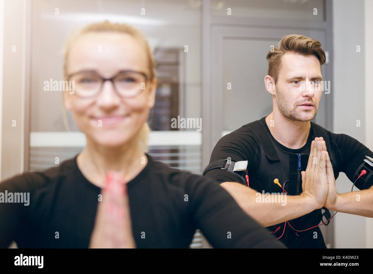 Close up front portrait of sportsman and his coach in yoga pose Stock ...