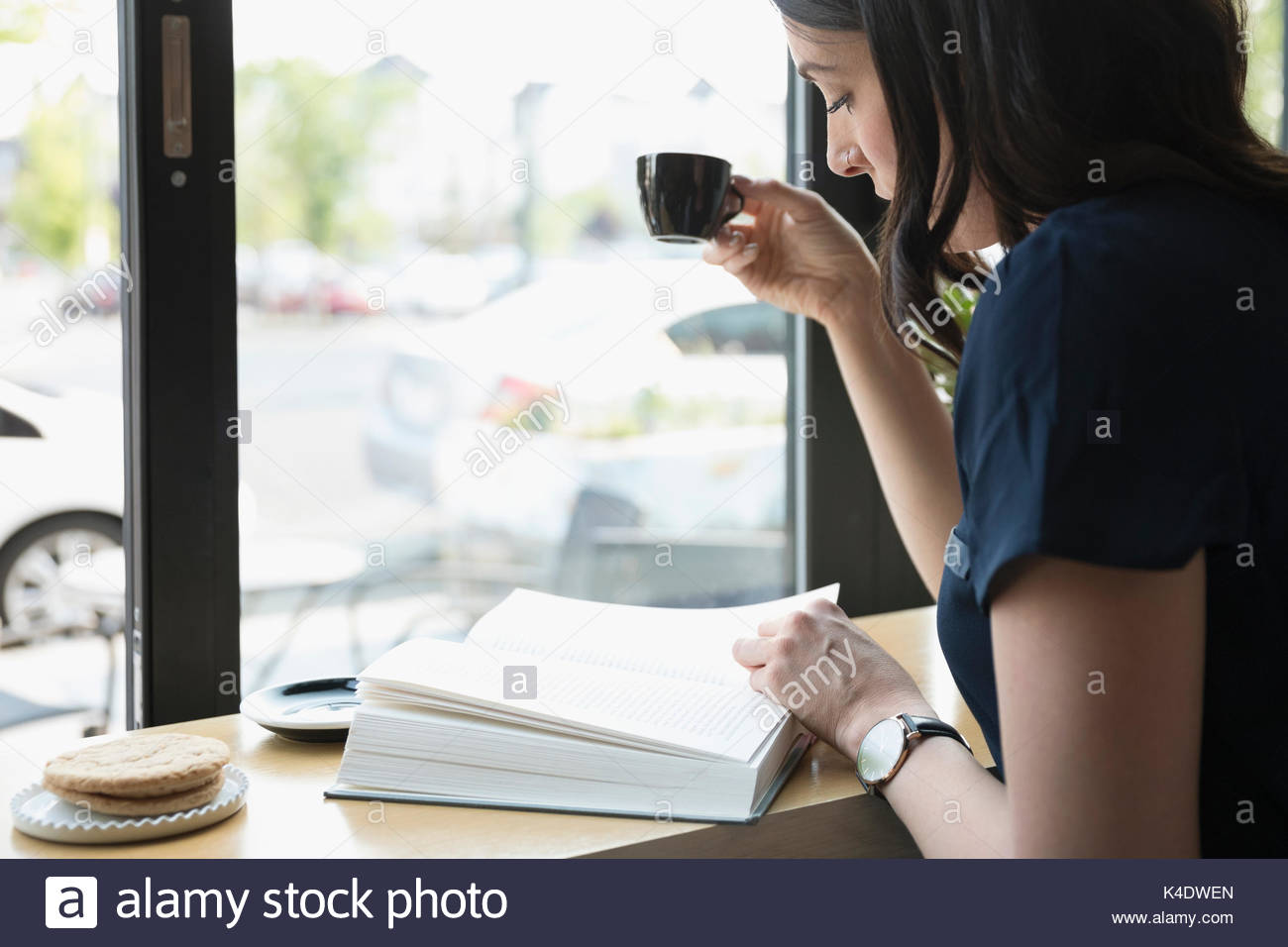 Reading a book, cafe hi-res stock photography and images - Alamy