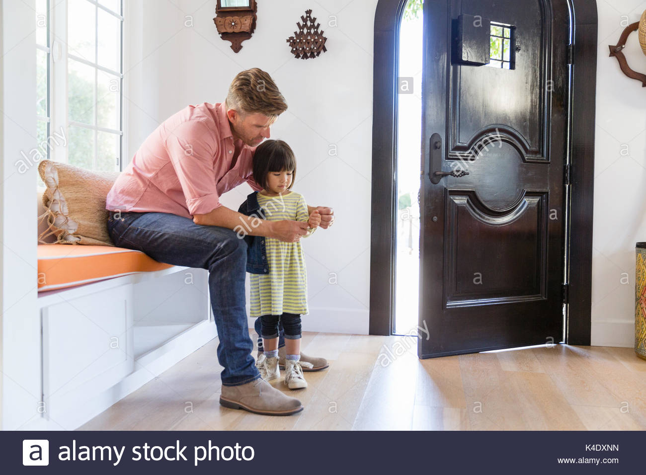 Child putting on jacket hi-res stock photography and images - Alamy
