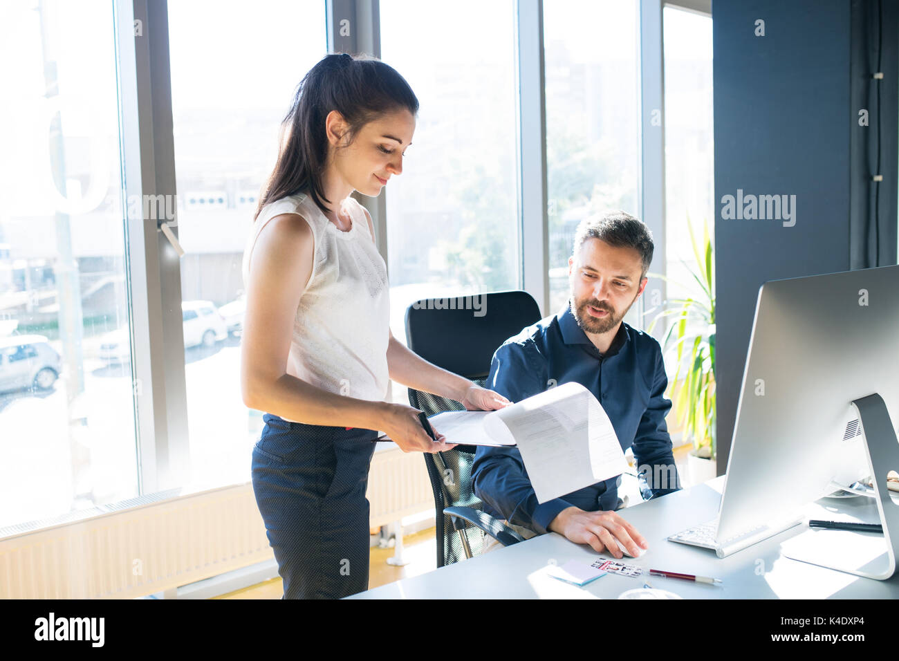 Two business people in the office working together Stock Photo - Alamy