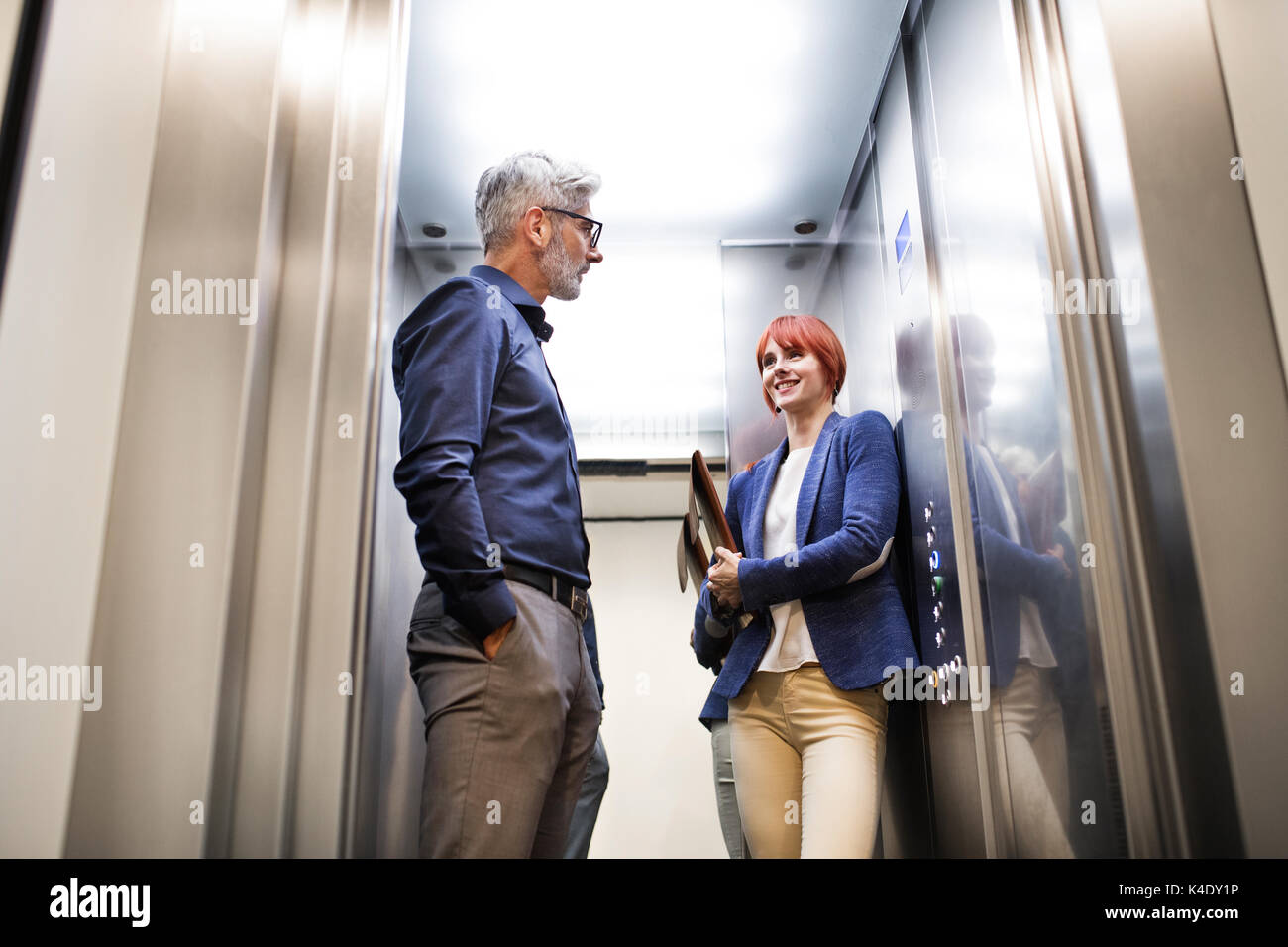 Business people in the elevator in modern office building Stock Photo ...