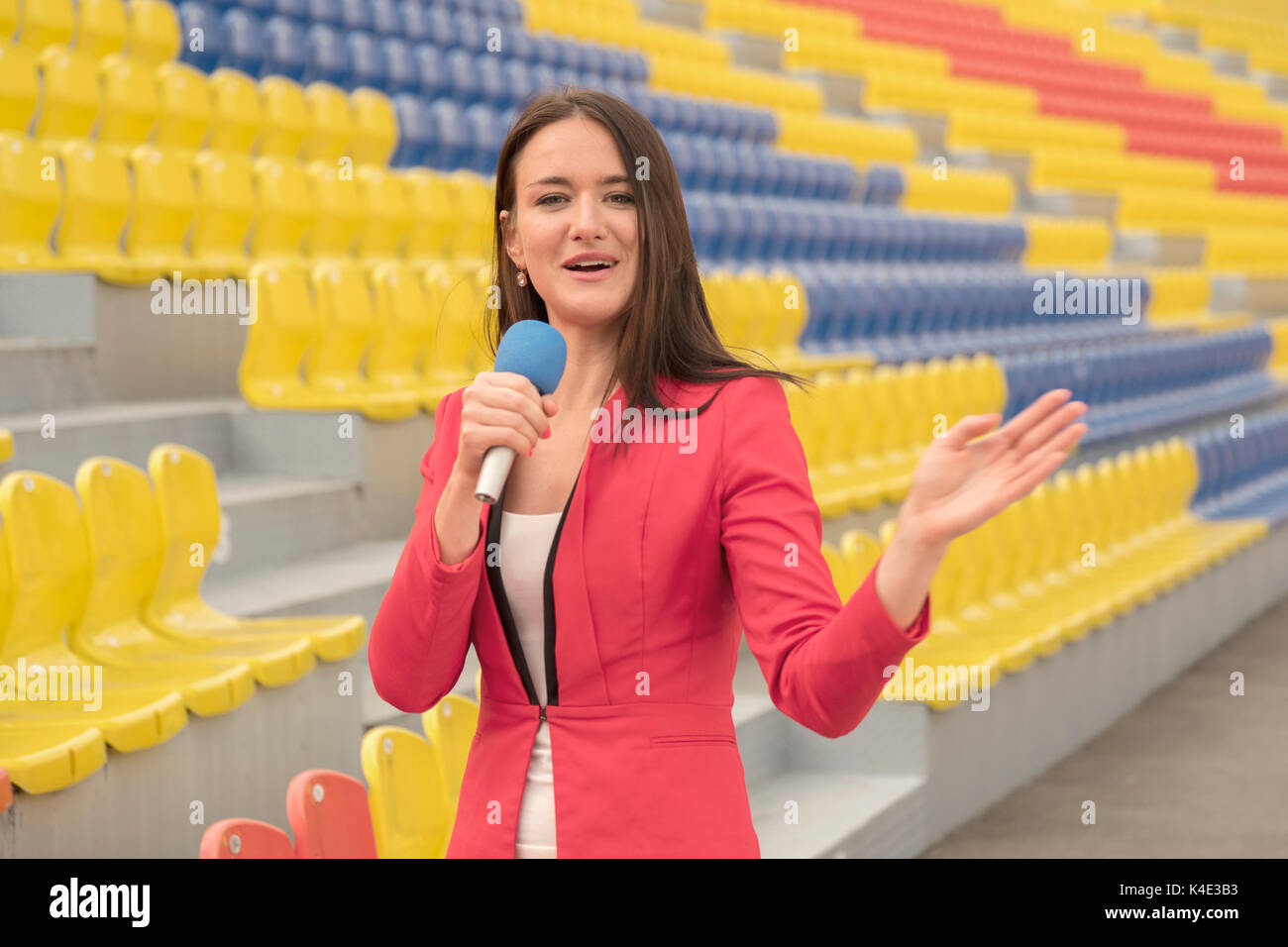 Pretty journalist is reporting from the stadium for television Stock ...
