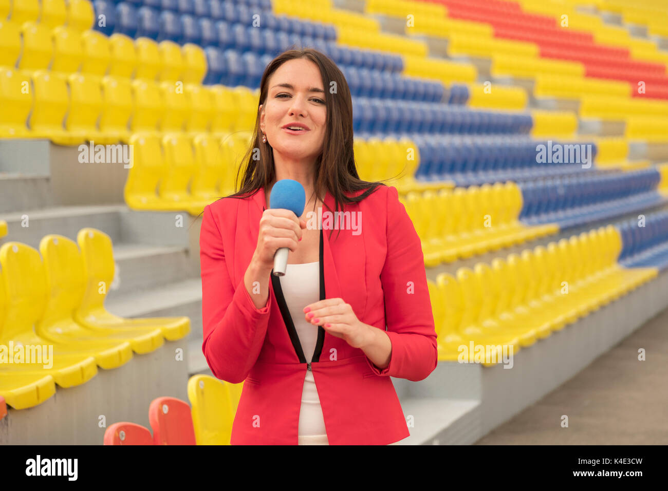 Pretty journalist is reporting from the stadium for television Stock ...