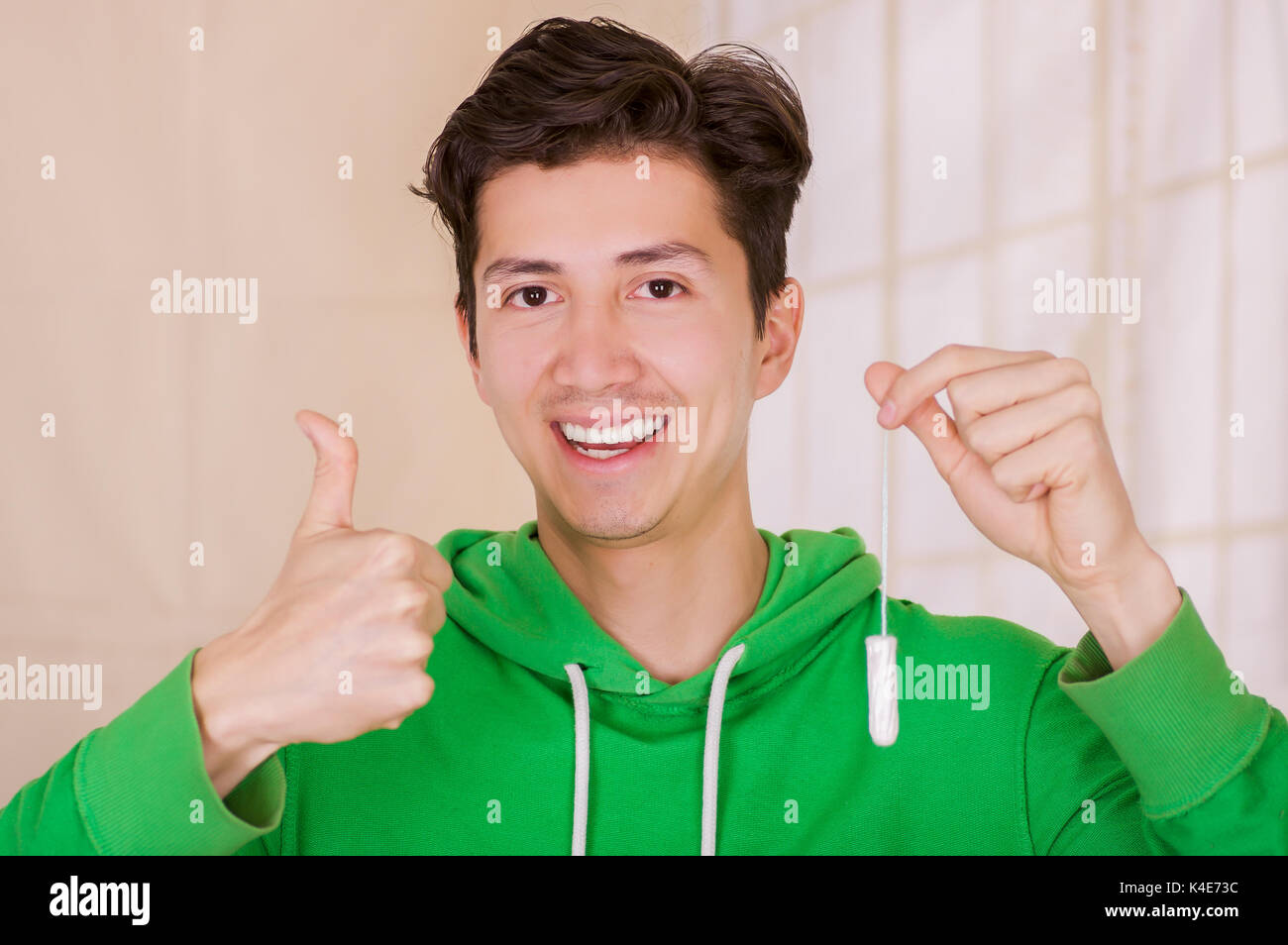 Handsome smiling man with a happy face holding a menstruation cotton ...