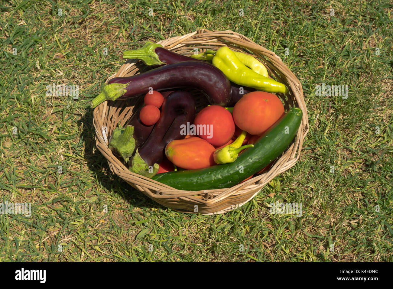 Composition with vegetables in wicker basket Stock Photo - Alamy