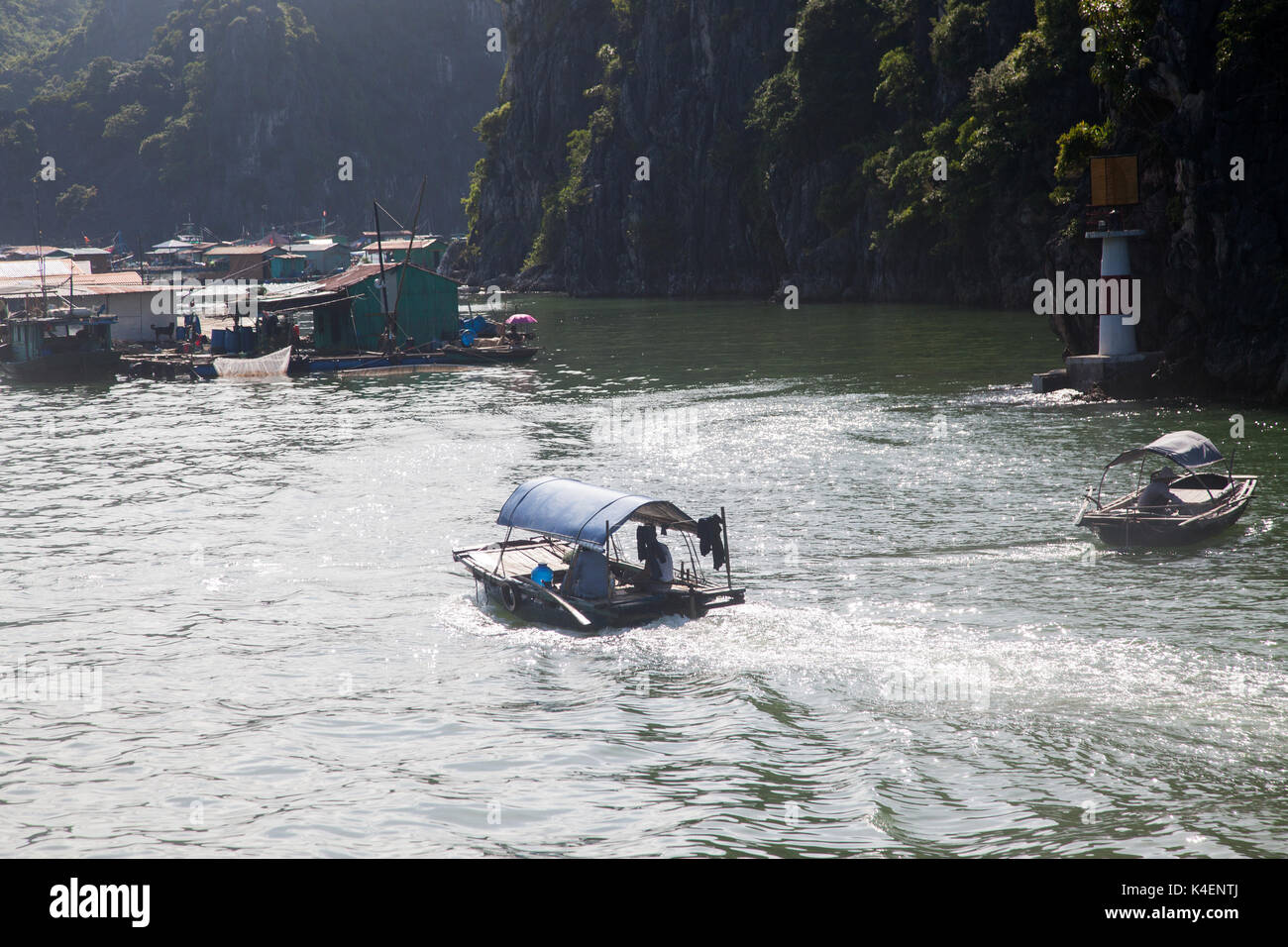 traditonal vietnamese boats and floating village near Cat Ba island ...