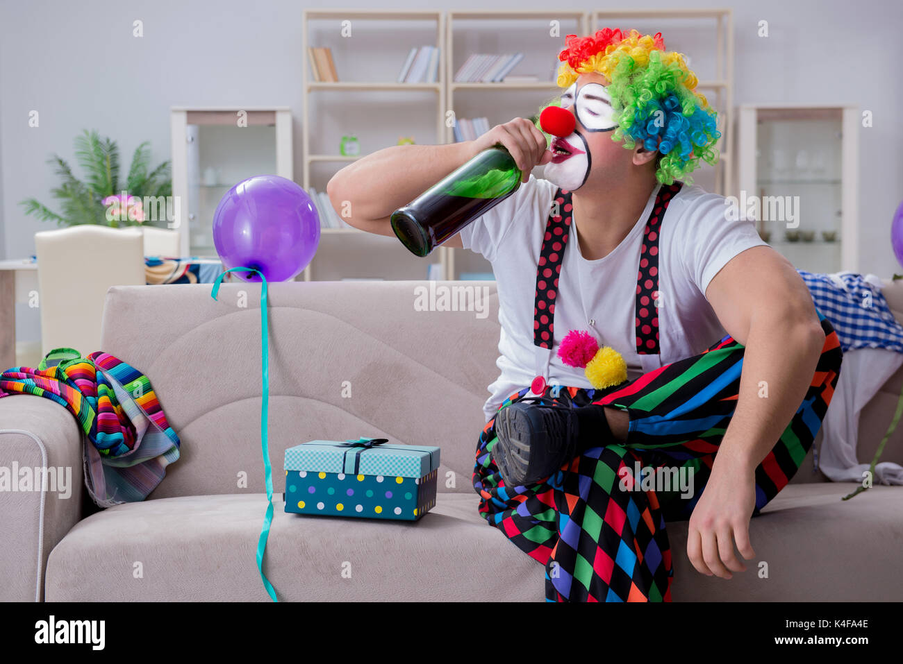 Drunk clown celebrating having a party at home Stock Photo - Alamy