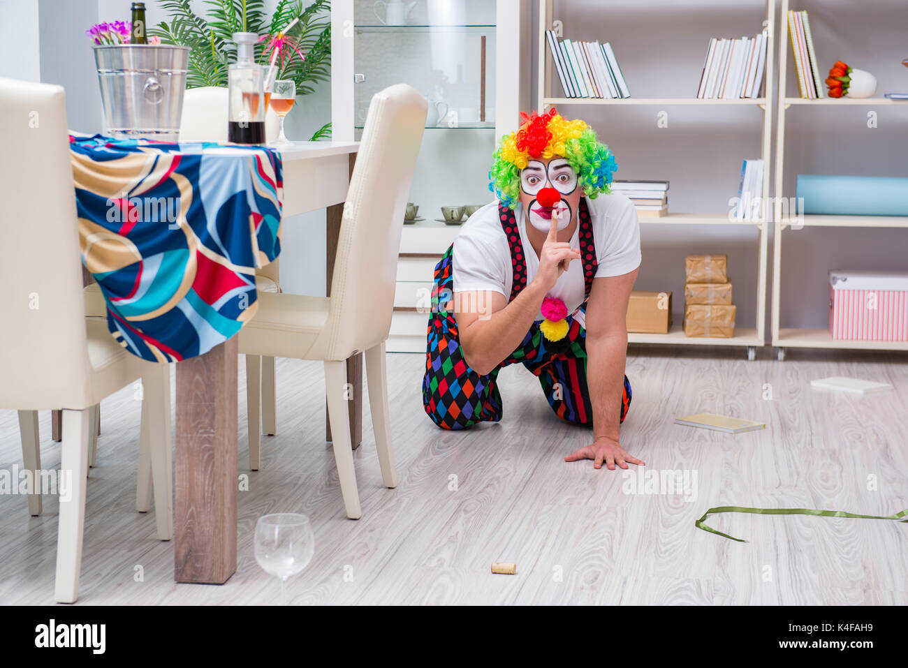 Drunk clown celebrating having a party at home Stock Photo - Alamy