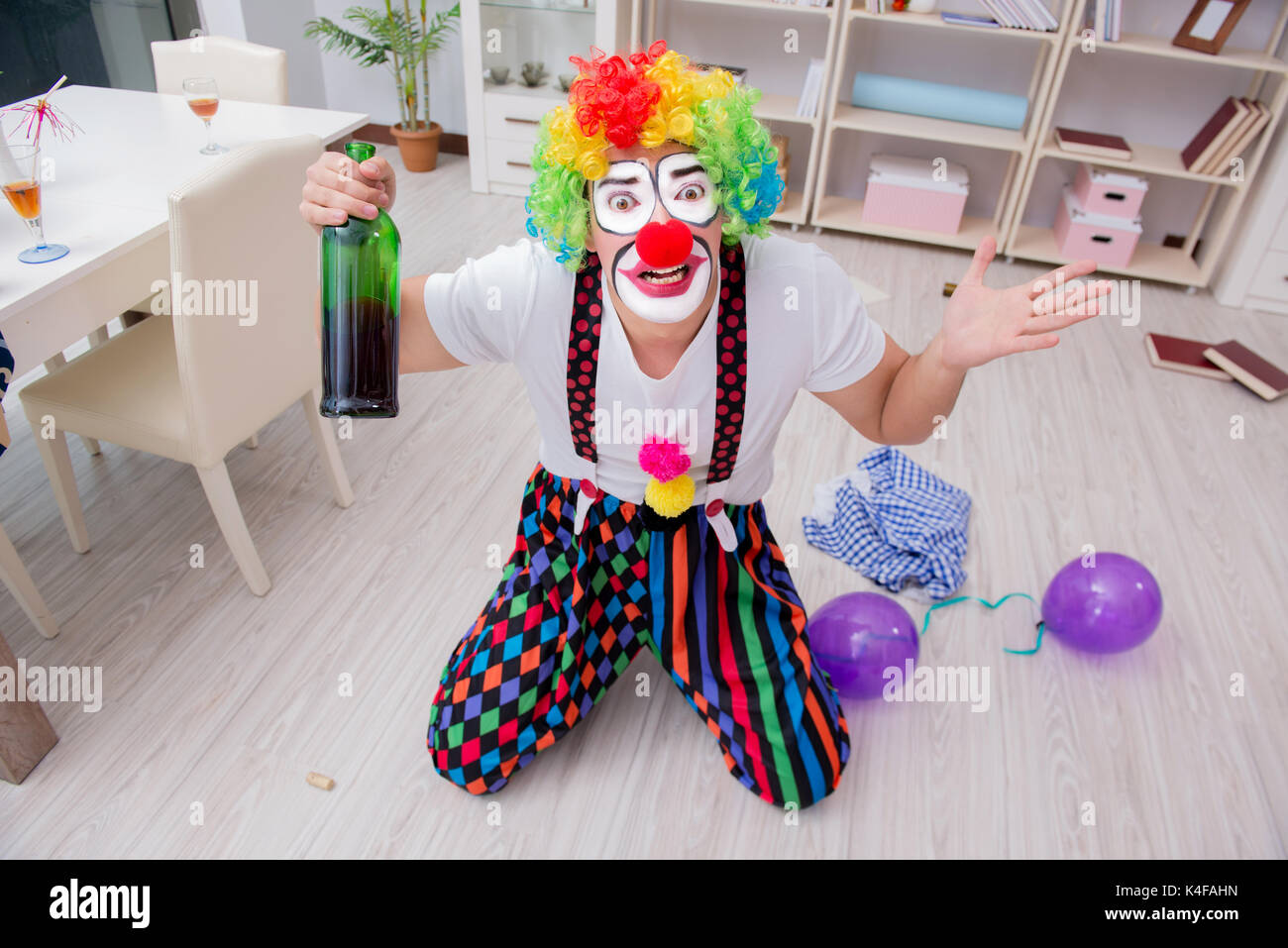 Drunk clown celebrating having a party at home Stock Photo - Alamy