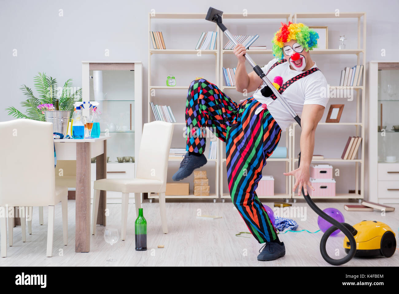 Funny clown doing cleaning at home Stock Photo - Alamy