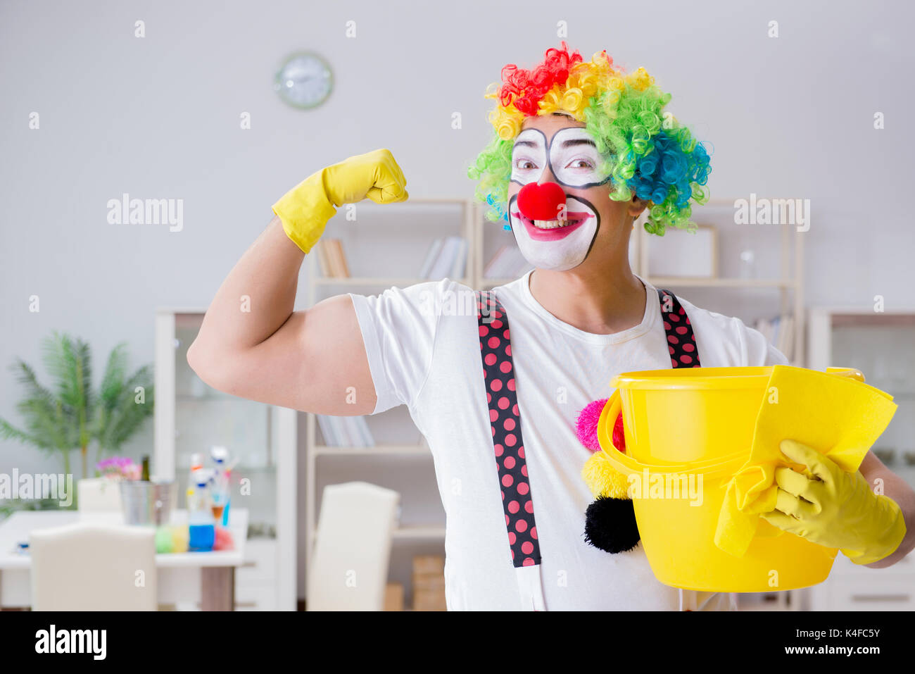 Funny clown doing cleaning at home Stock Photo - Alamy