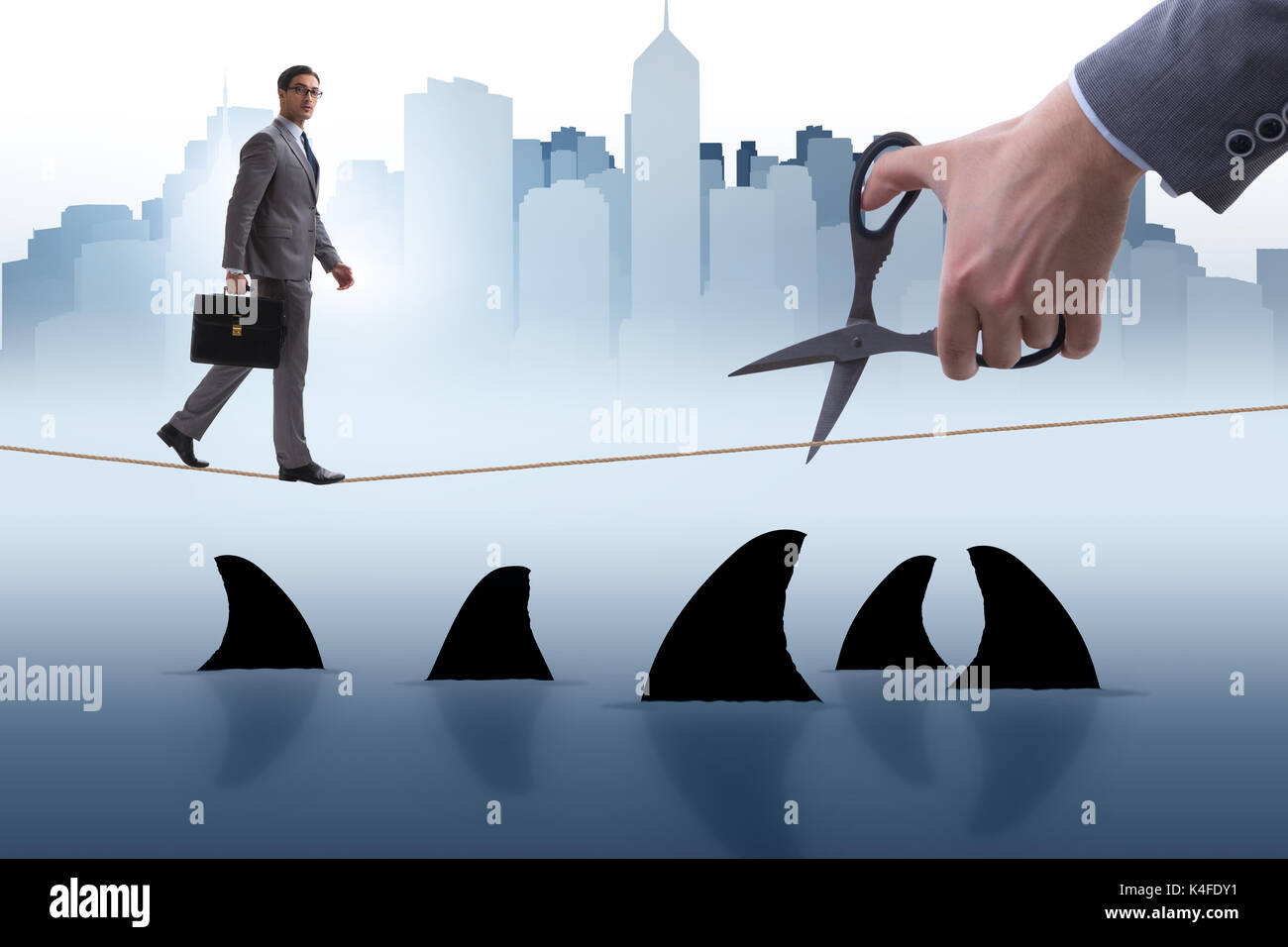 Hand cutting rope in business risk concept Stock Photo - Alamy