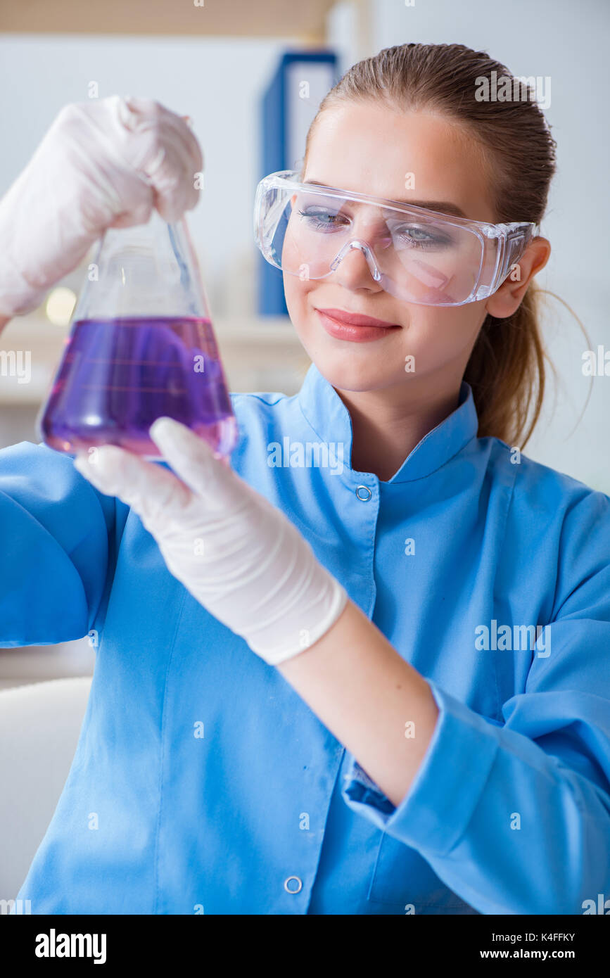 Female scientist researcher conducting an experiment in a laboratory ...