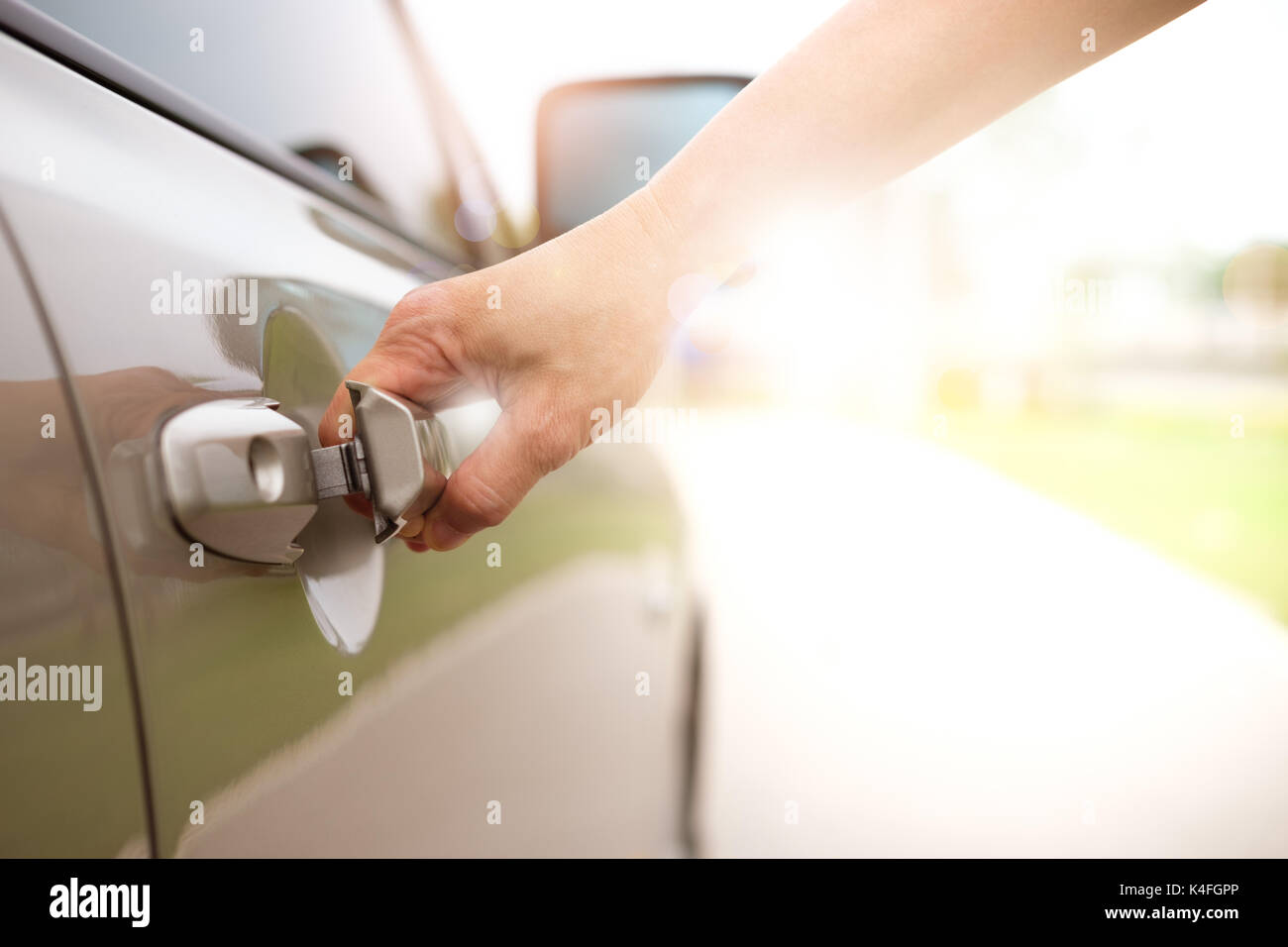 Woman's hand pulling a car's door handle in the park Stock Photo - Alamy