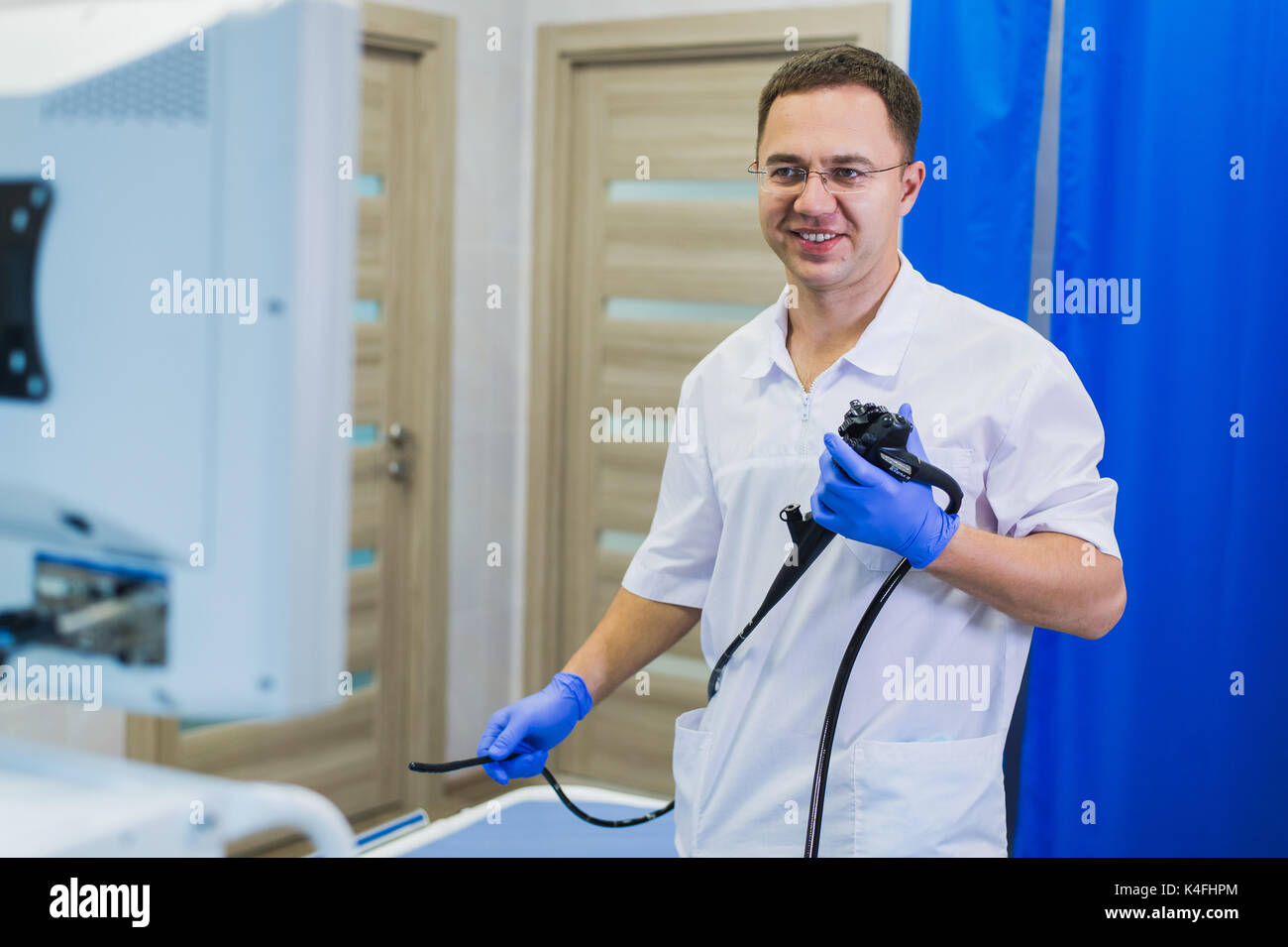 happy proctologist holding anoscope at hospital ward Stock Photo - Alamy