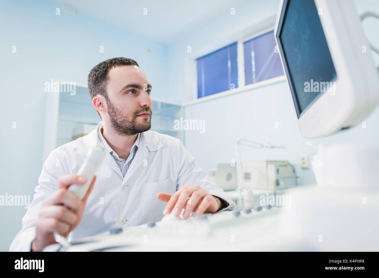 Portrait of a thinking doctor near sceen of medical equipment Stock ...
