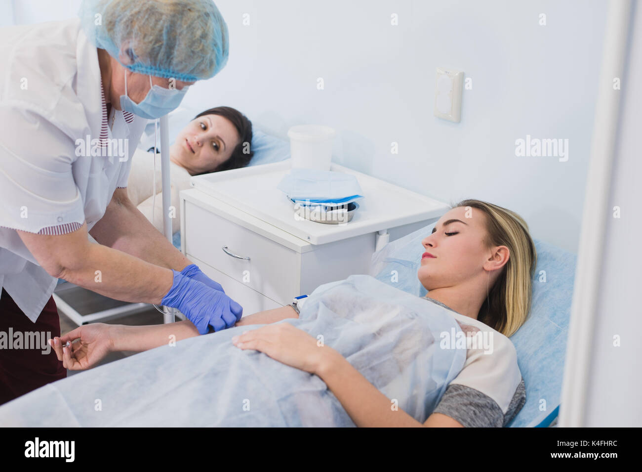 Nurse connecting an intravenous drip in hospital room Stock Photo - Alamy