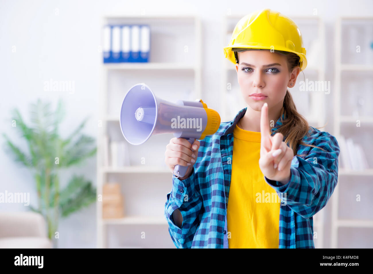 Angry building supervisor with megaphone Stock Photo - Alamy