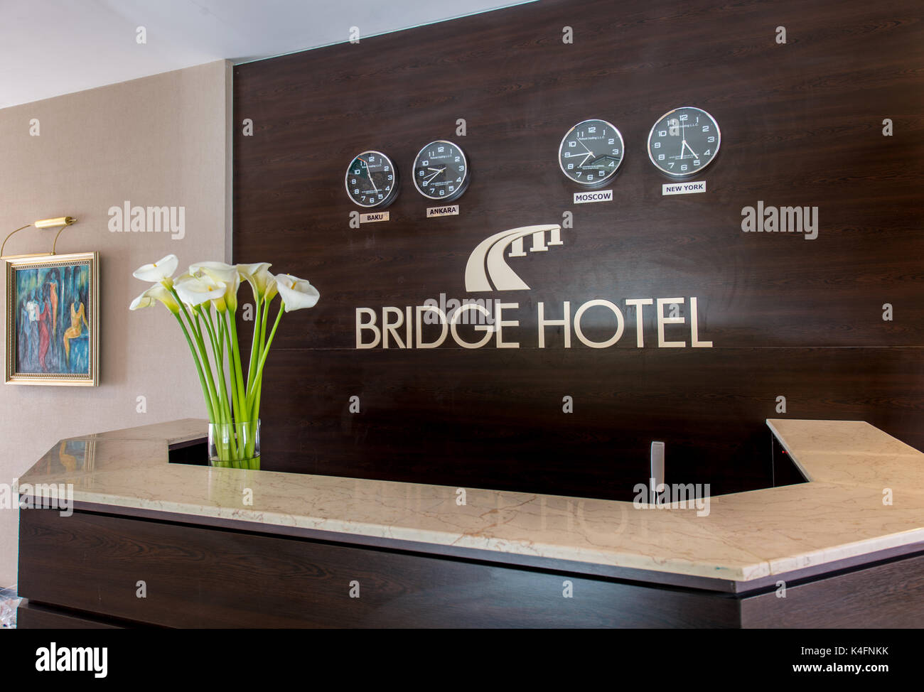 Hotel reception with desk and clocks Stock Photo - Alamy