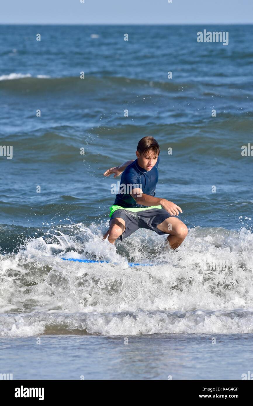 Surfer riding waves at the beach Stock Photo - Alamy