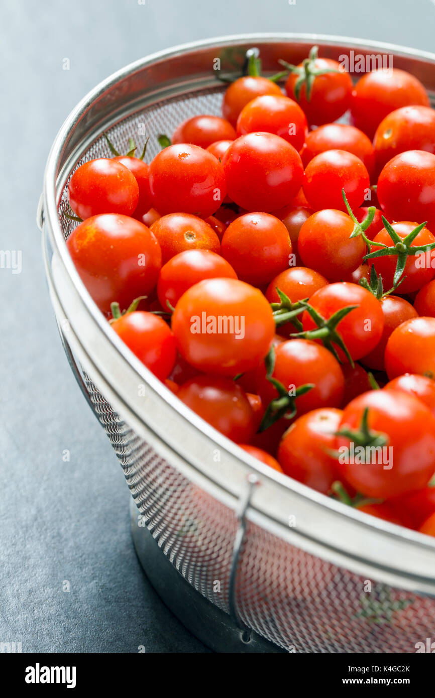 Fresh Cherry Tomato in the silver colander Stock Photo - Alamy