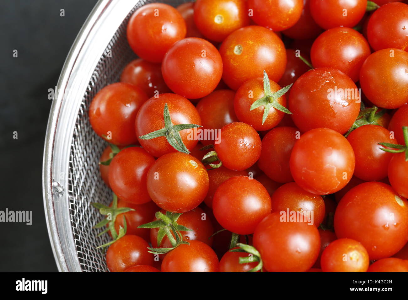 Fresh Cherry Tomato in the silver colander Stock Photo - Alamy