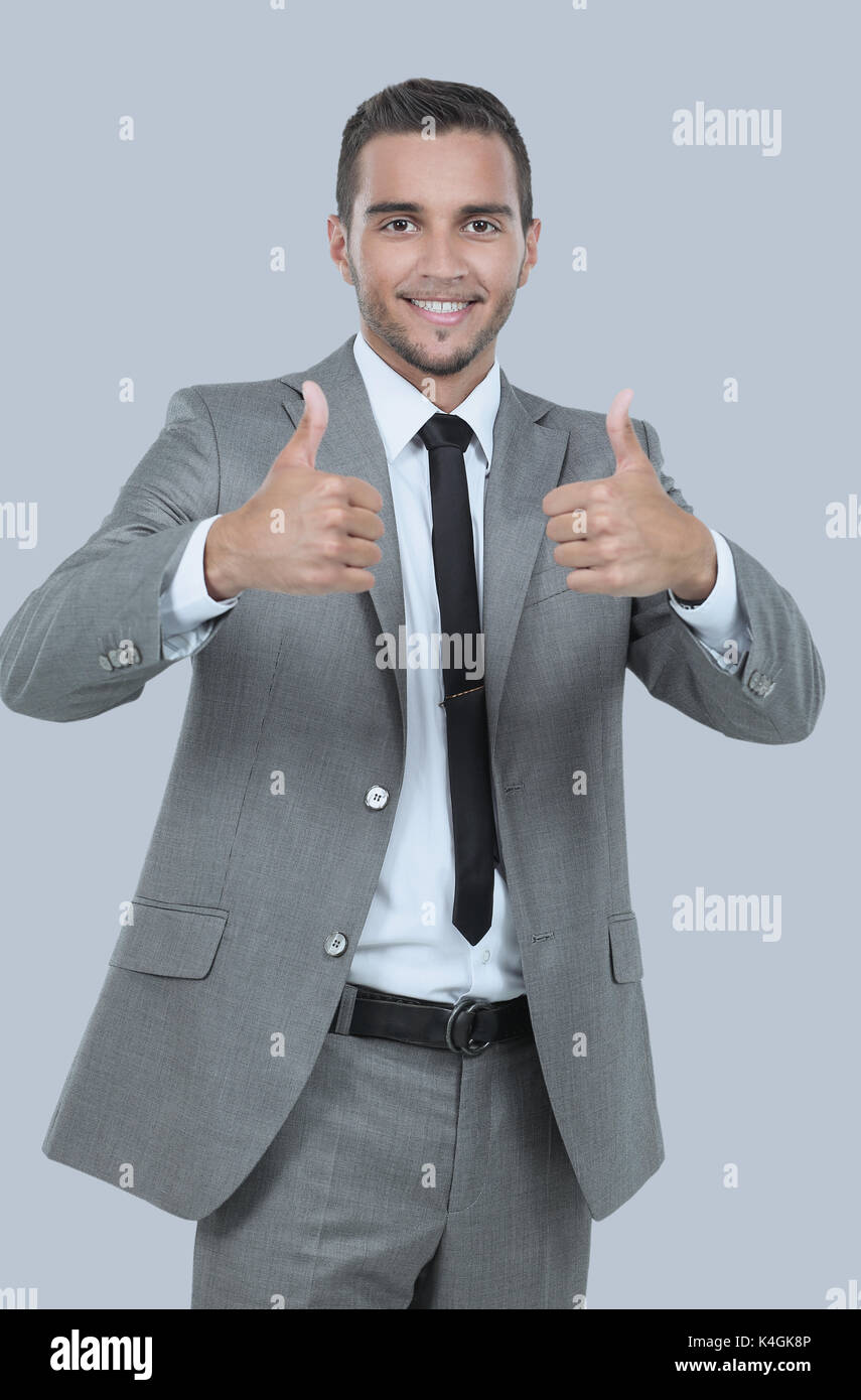 Handsome young manager showing thumbs up isolated on gray Stock Photo ...