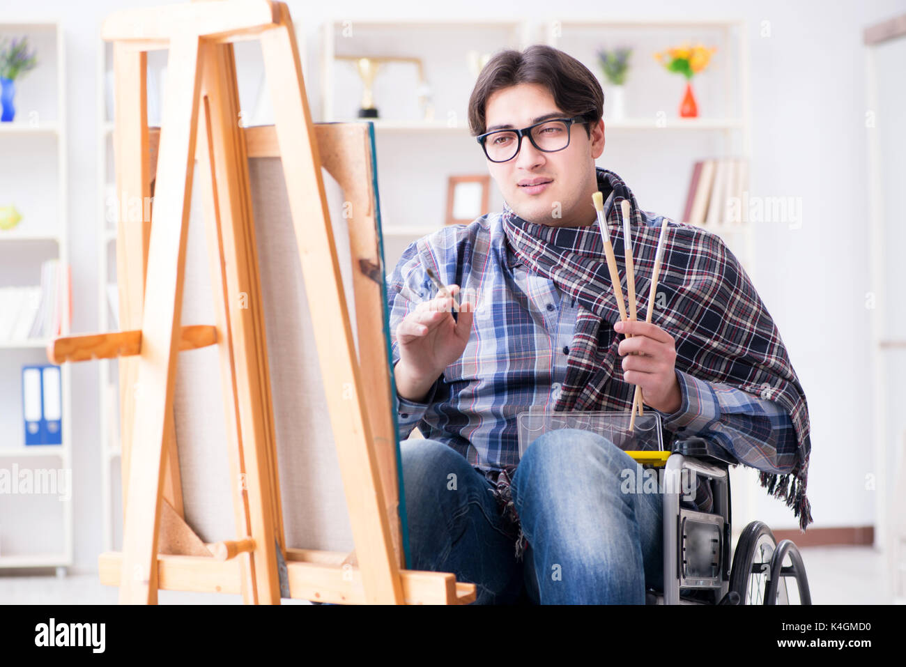 Disabled artist painting picture in studio Stock Photo - Alamy