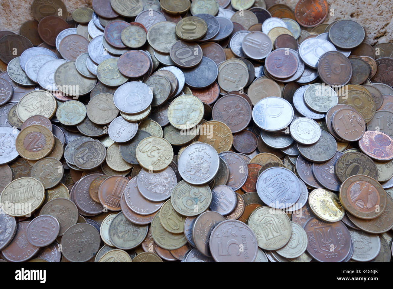 Pile of world coins Stock Photo - Alamy