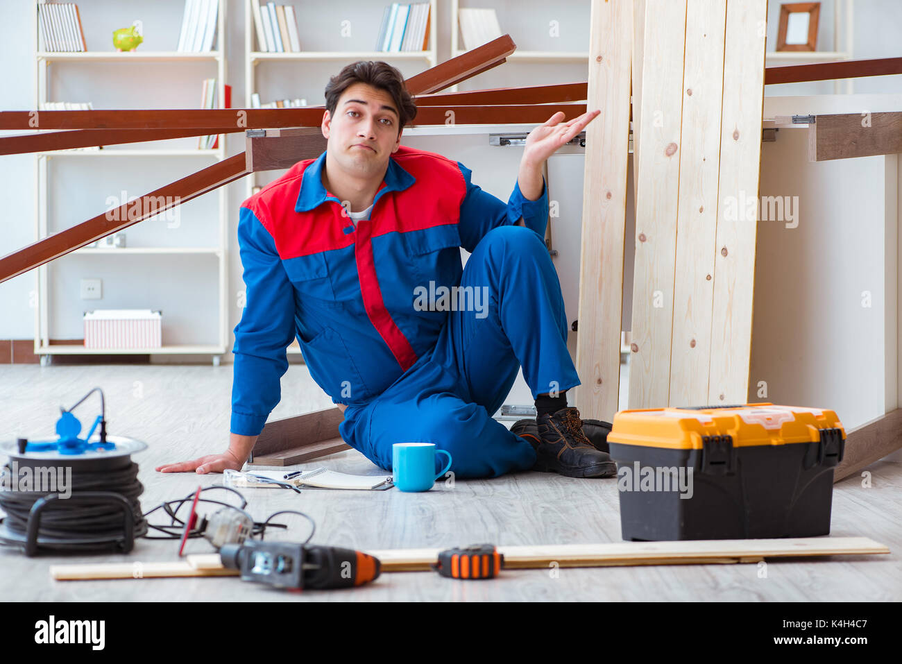 Young carpenter with notebook writing planning at construction repair ...