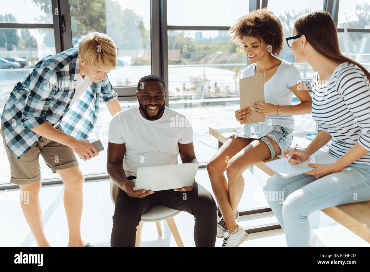 Cheerful international students working together on the project Stock ...