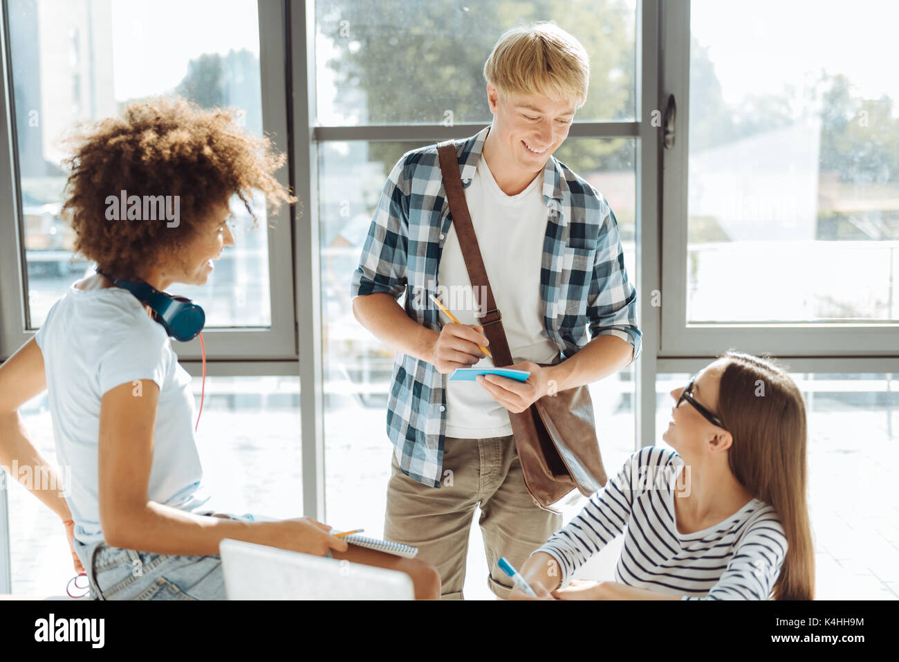 Positive young students enjoying nice talk Stock Photo - Alamy