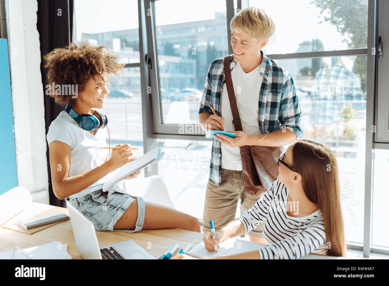 Positive young students making notes Stock Photo - Alamy