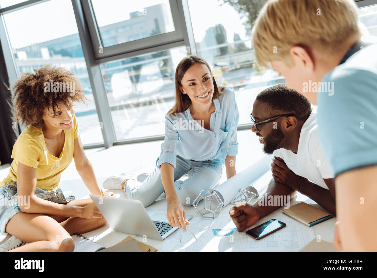 Positive international students working together on the university ...