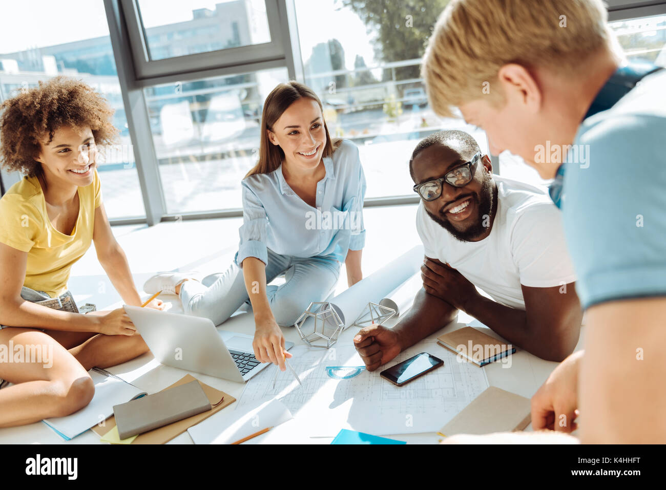 Positive international students discussing their university project ...