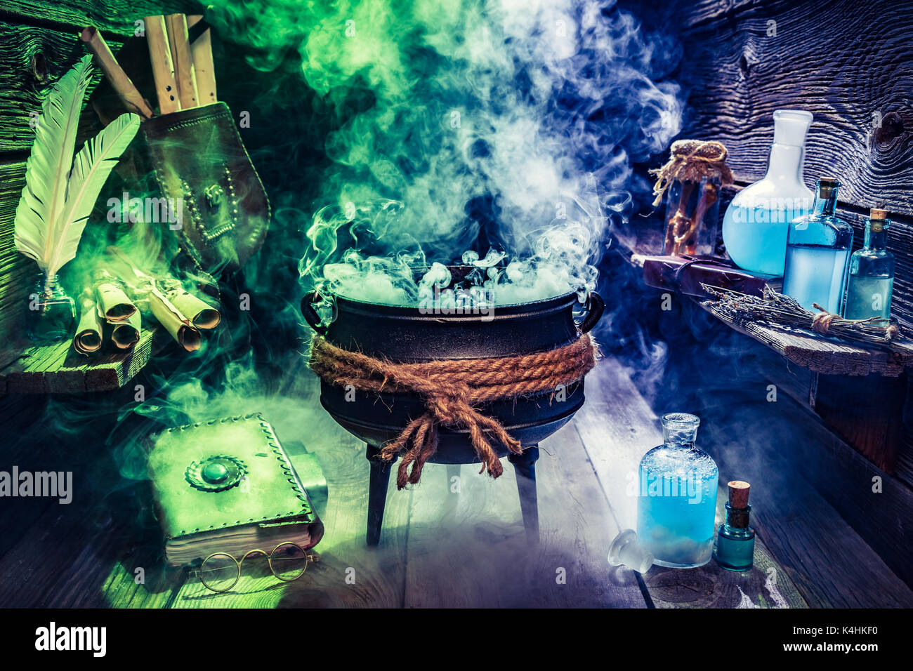 Magic witch pot with books, scrolls and potions Stock Photo - Alamy