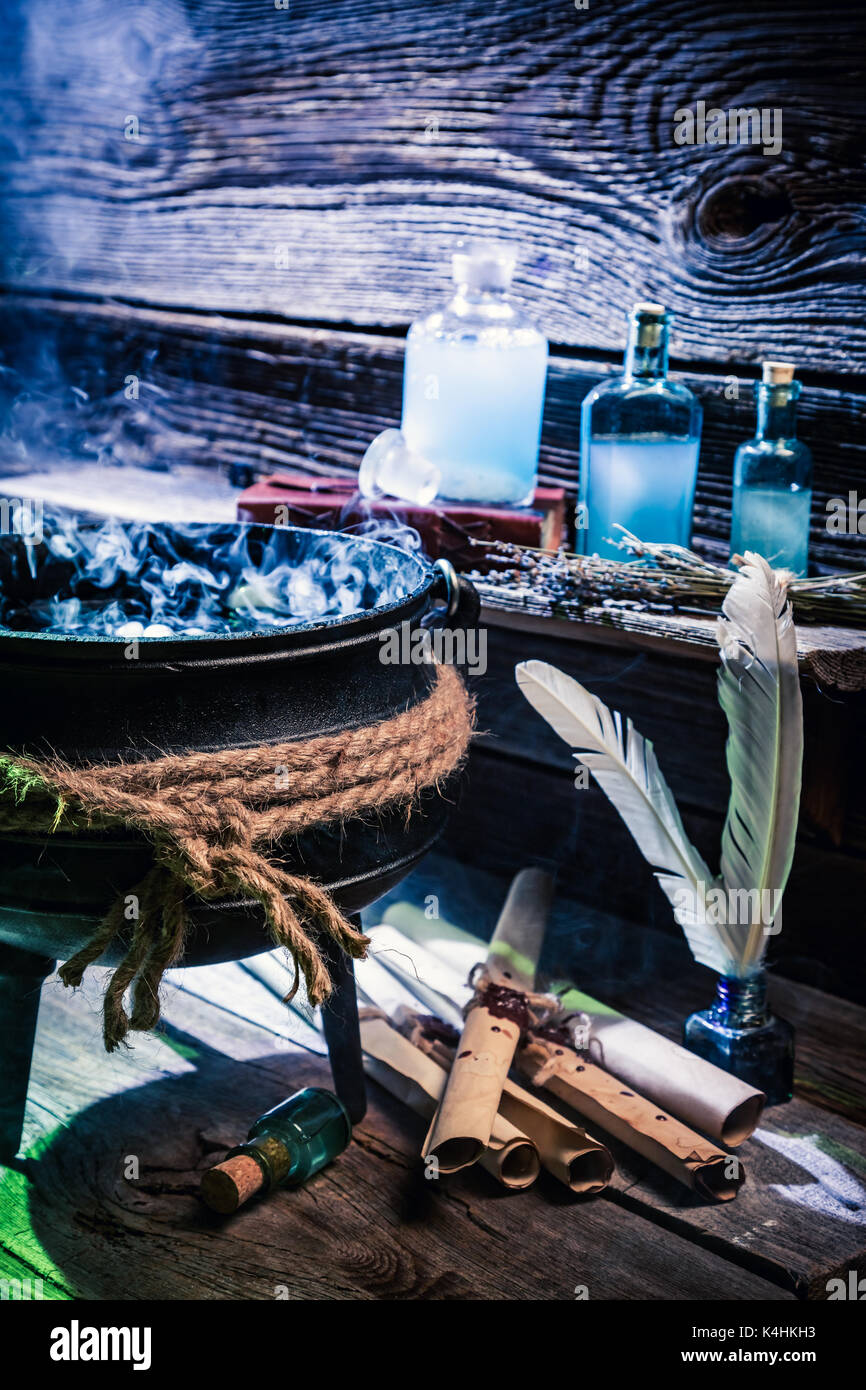Witch pot with potions and old scrolls for Halloween Stock Photo - Alamy