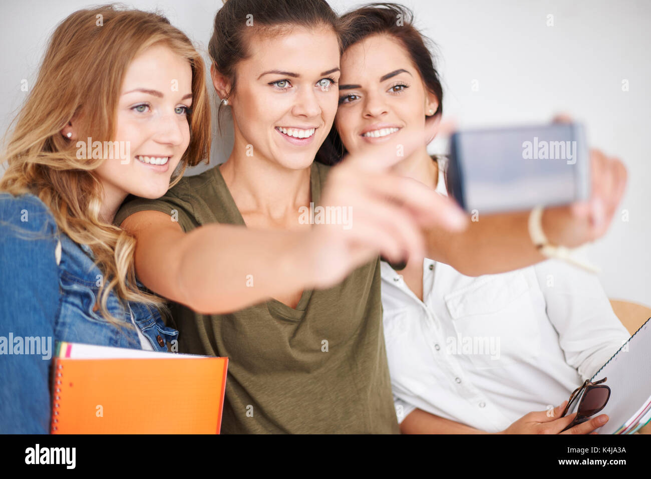 Adding images to social network with friends Stock Photo - Alamy