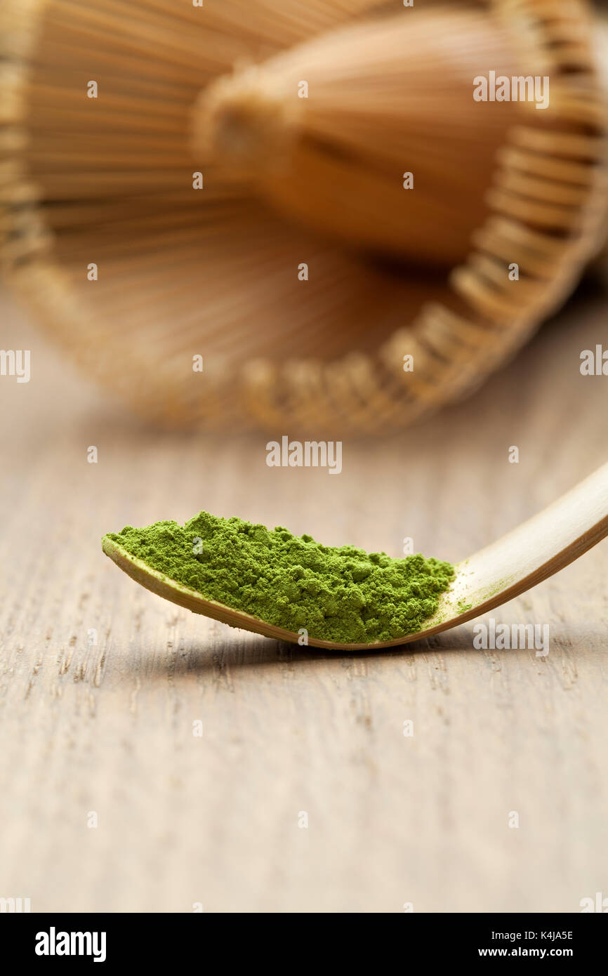 Japanese bamboo matcha spoon, chashaku, with green tea and chasen on ...