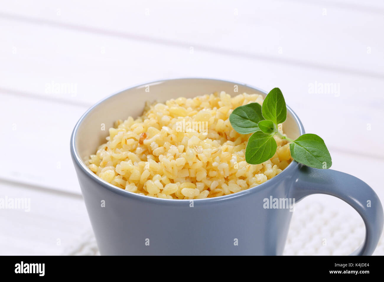 Cooked whole groats in a cup Stock Photo - Alamy