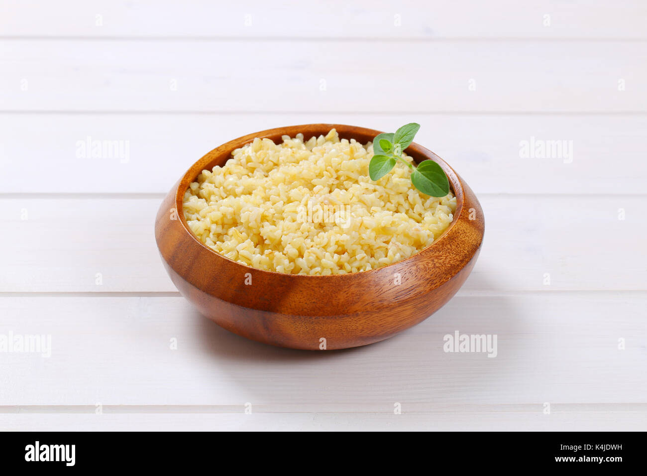Cooked whole groats in wooden bowl Stock Photo - Alamy
