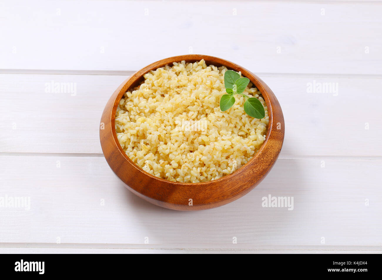 Cooked whole groats in wooden bowl Stock Photo - Alamy
