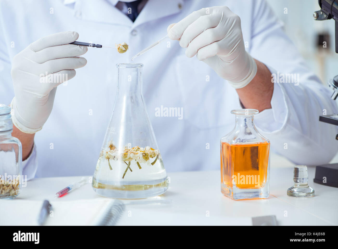 Chemist mixing perfumes in the lab Stock Photo - Alamy