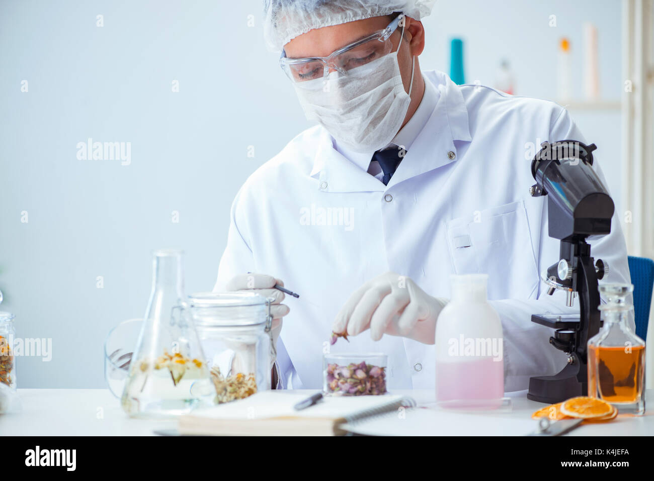 Chemist mixing perfumes in the lab Stock Photo - Alamy