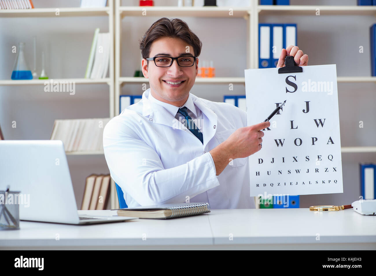 Doctor optician with letter chart conducting an eye test check Stock ...