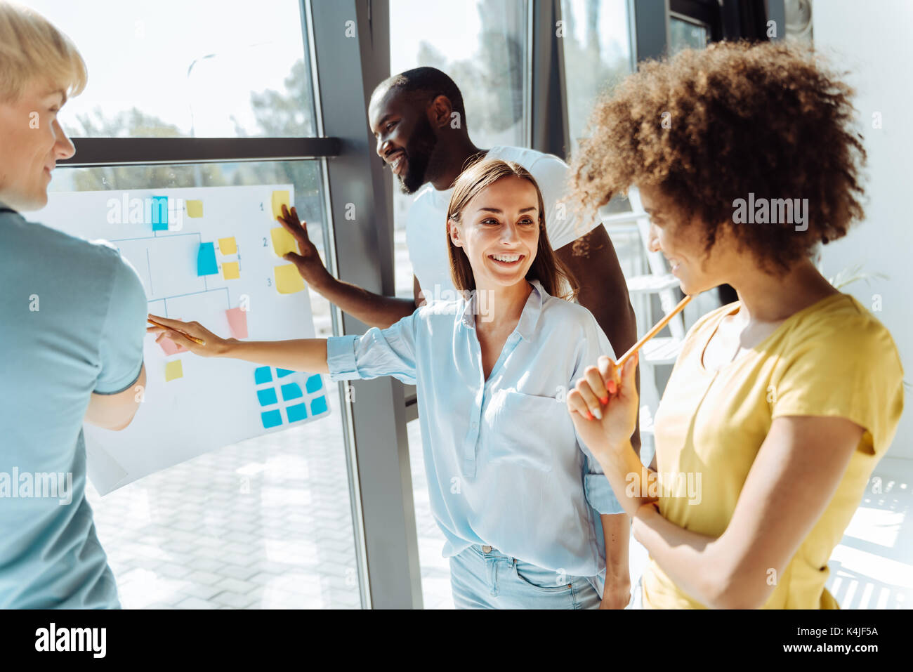 Cheerful young colleagues enjoying the teamwork Stock Photo - Alamy