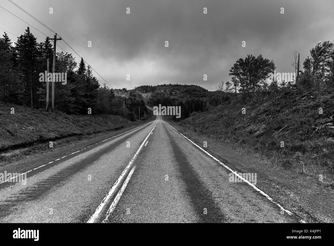 Empty road passing through rural landscape, St. Peter's, Cape Breton ...