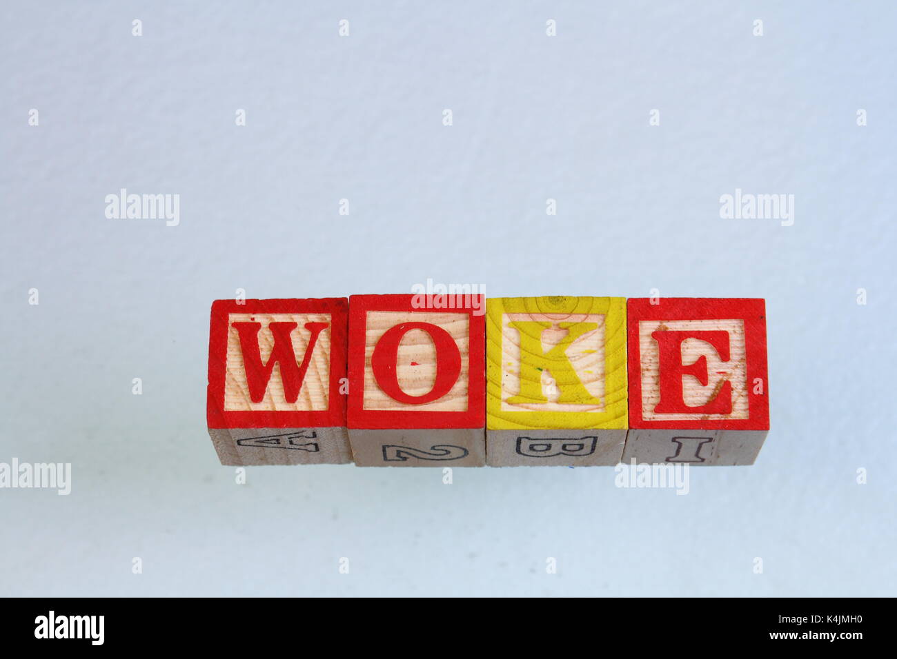 The term woke displayed visually on a white background using colorful ...