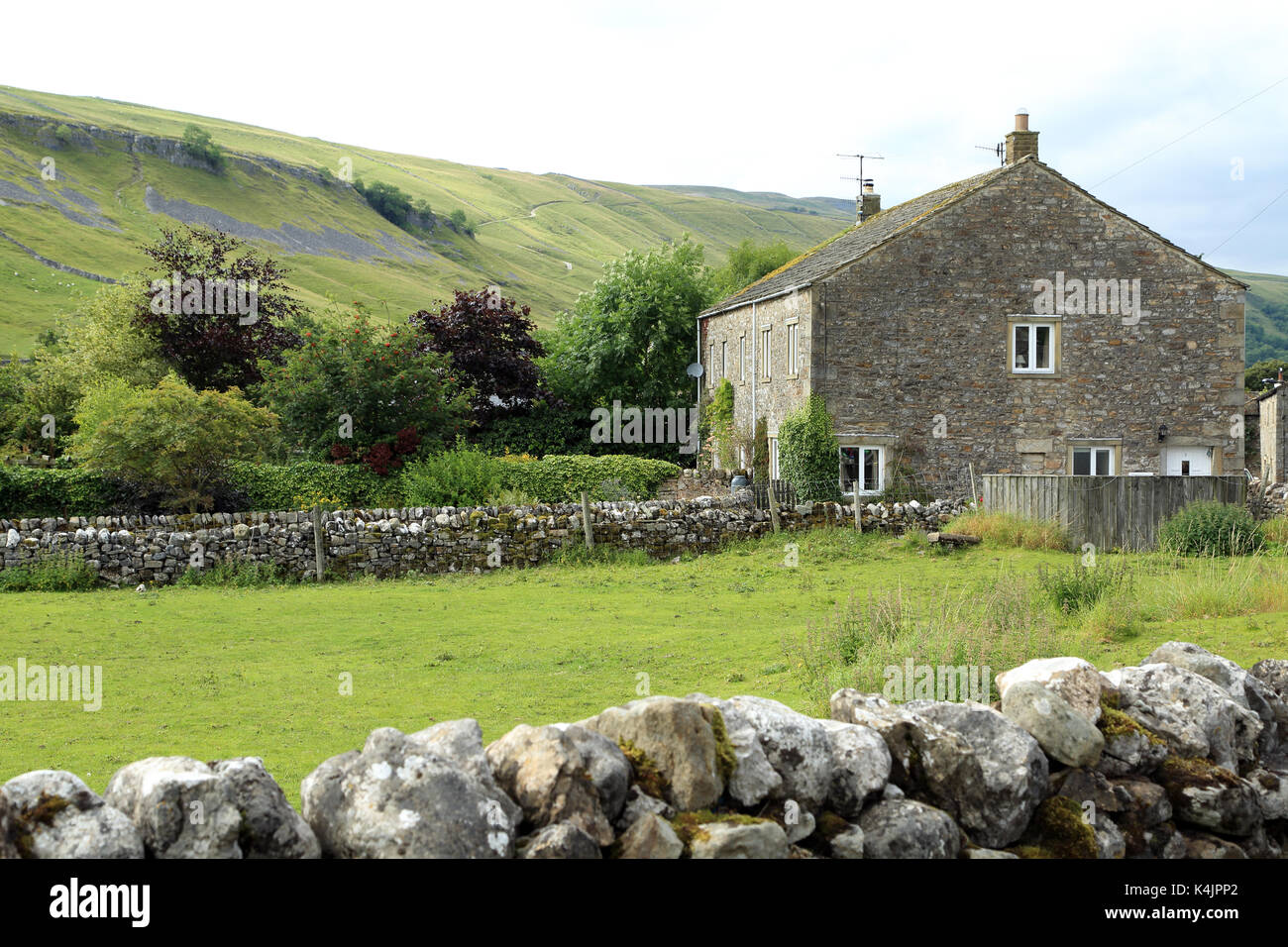 Traditional stone farmhouse with field and Hawkswick Moor in the ...