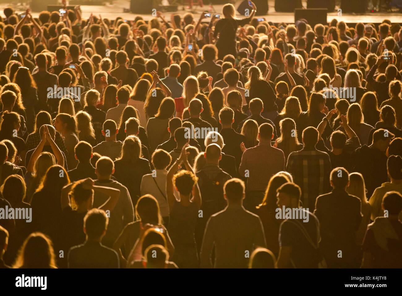 Anonymous crowd of people standing during mass event Stock Photo - Alamy